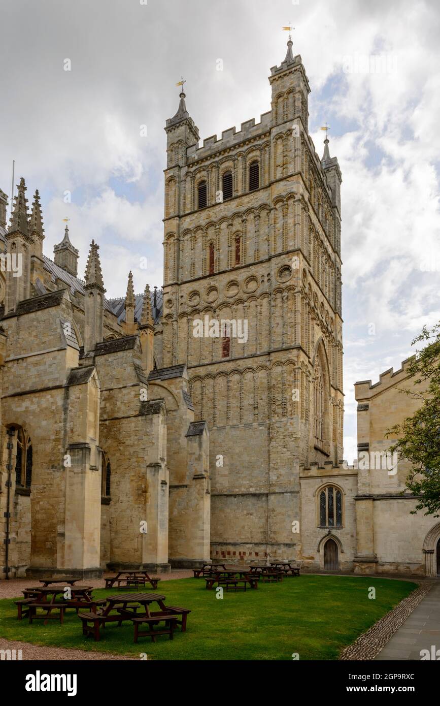 side view of massive buttresses and huge bell-tower of ancient stone ...