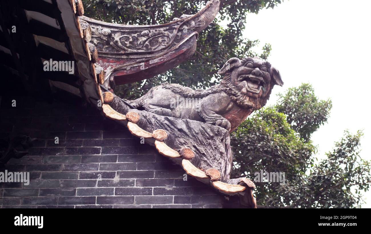close up of a dragon lion sculpture decorate on a roof of an old ...