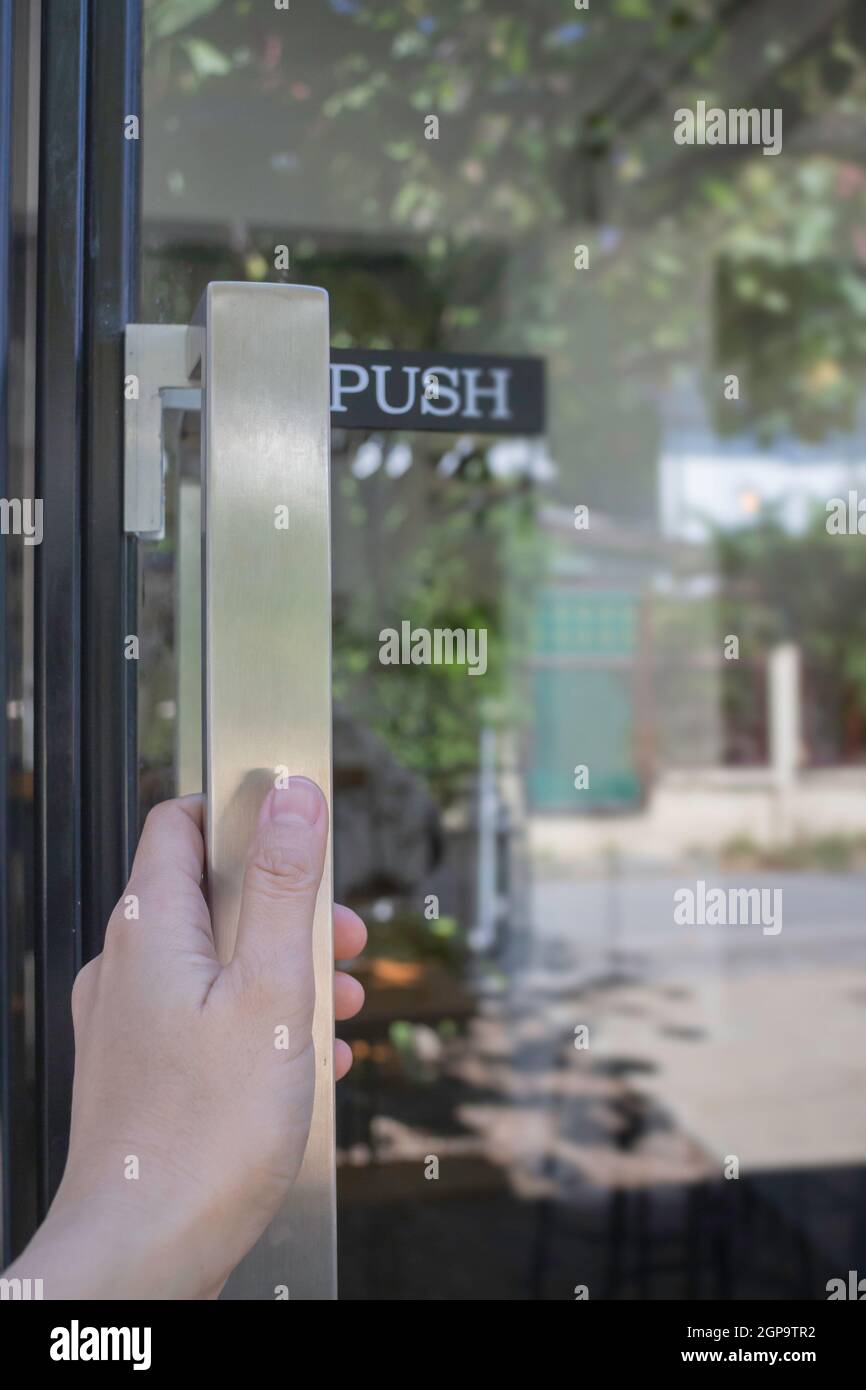 Hand on handle door for open to entering restaurant, stock photo Stock ...