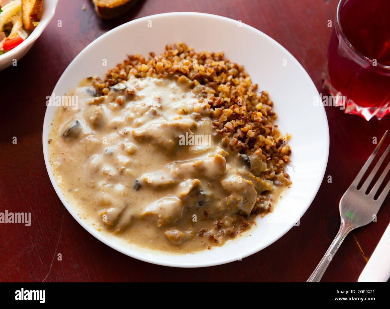 Popular dish of Russian cuisine is beef stroganoff with buckwheat ...