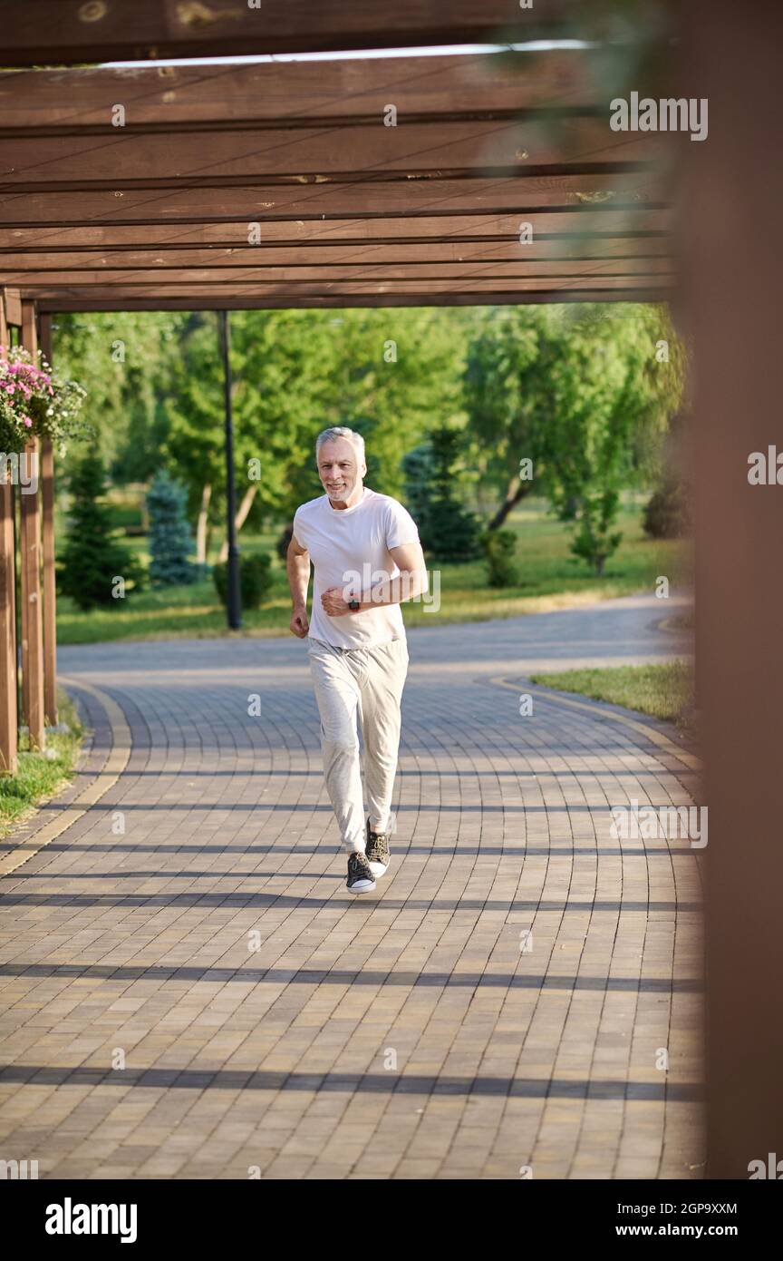 Man in sporstwear jogging hi-res stock photography and images - Alamy