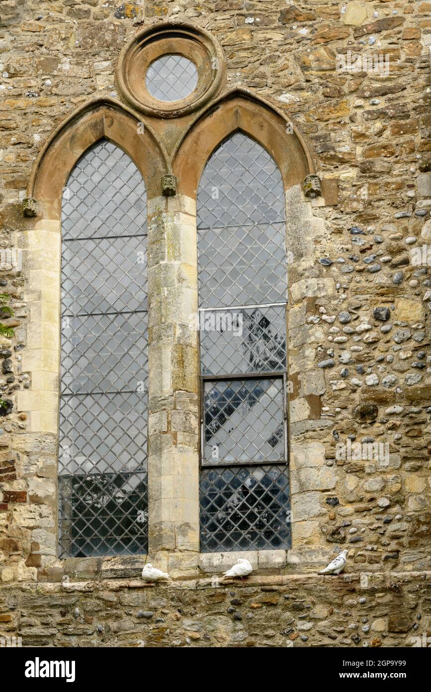 detail of a stained-glass mullioned window of ancient stone church in ...