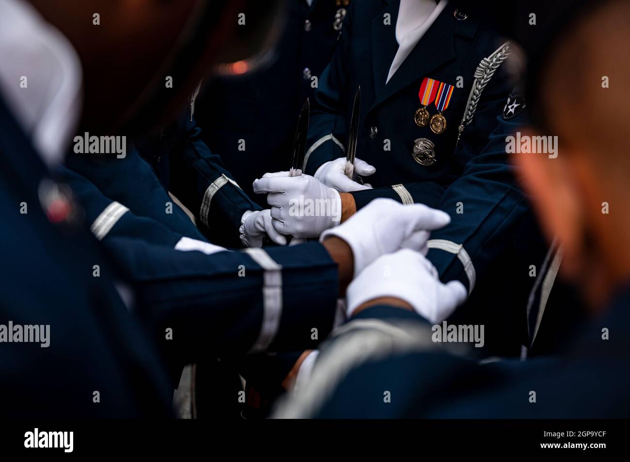 Members of the United States Air Force Honor Guard put their hands in ...