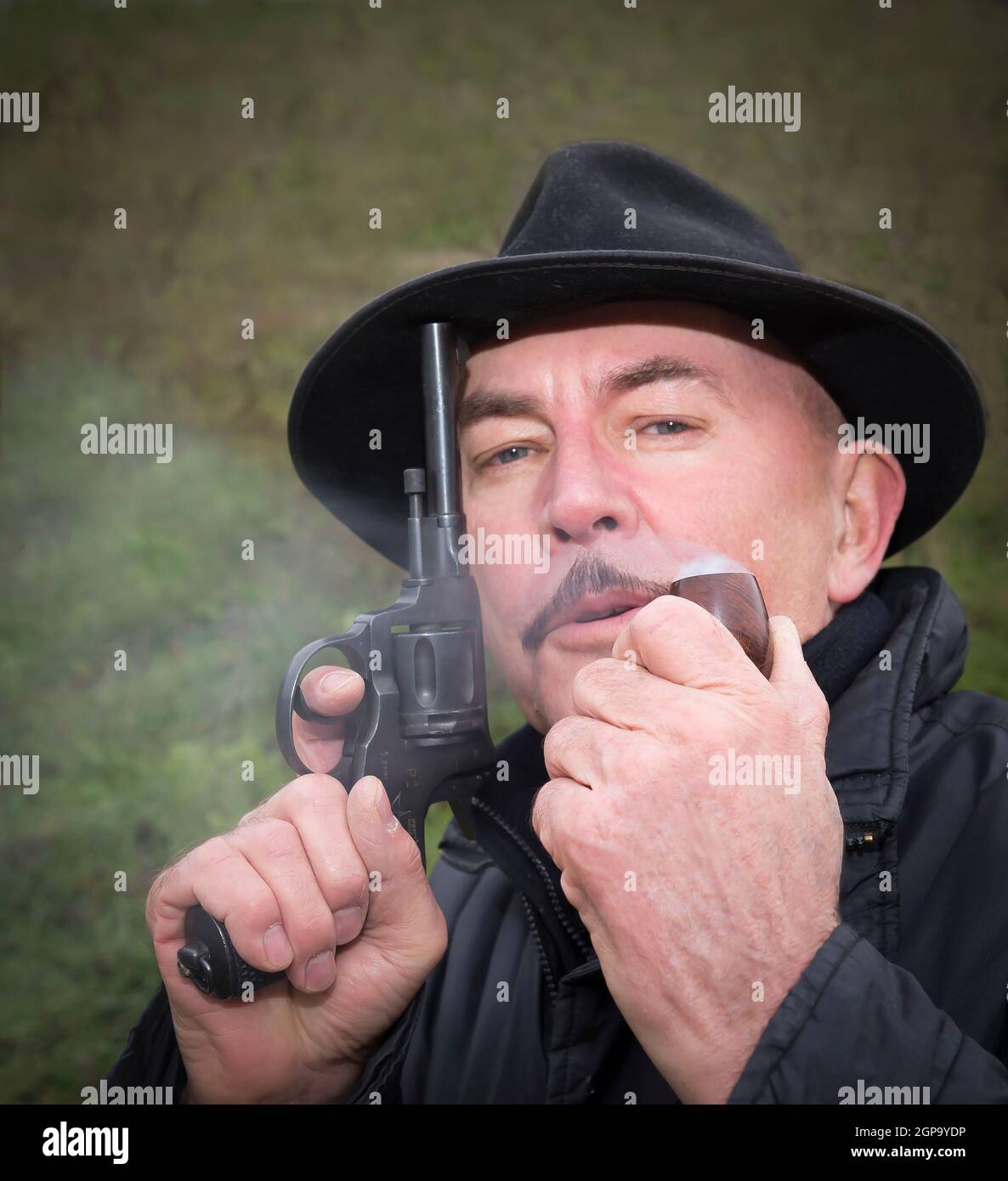 Man with gun system Nagan smoking his pipe Stock Photo - Alamy