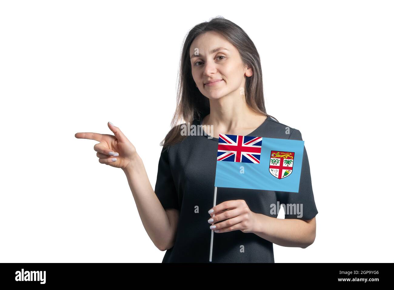 Happy young white woman holding flag Fiji and points to the left ...