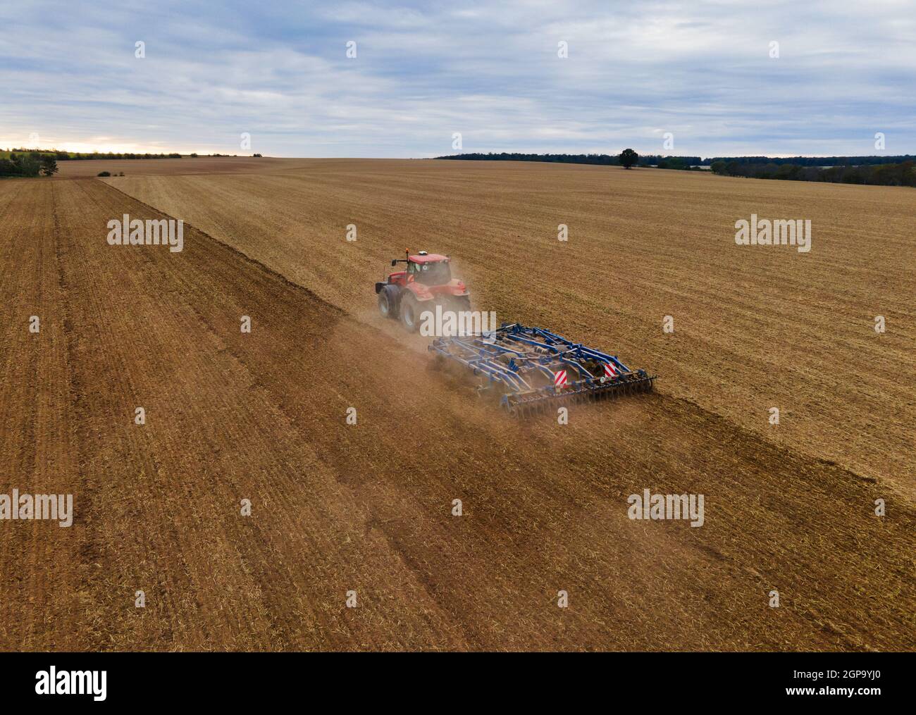 Farmer with tractor on wide field tilling the soil, aerial shot Stock ...