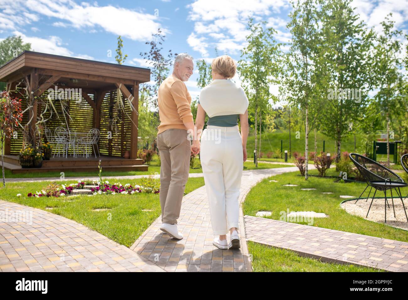 Man and his wife strolling hand in hand Stock Photo - Alamy