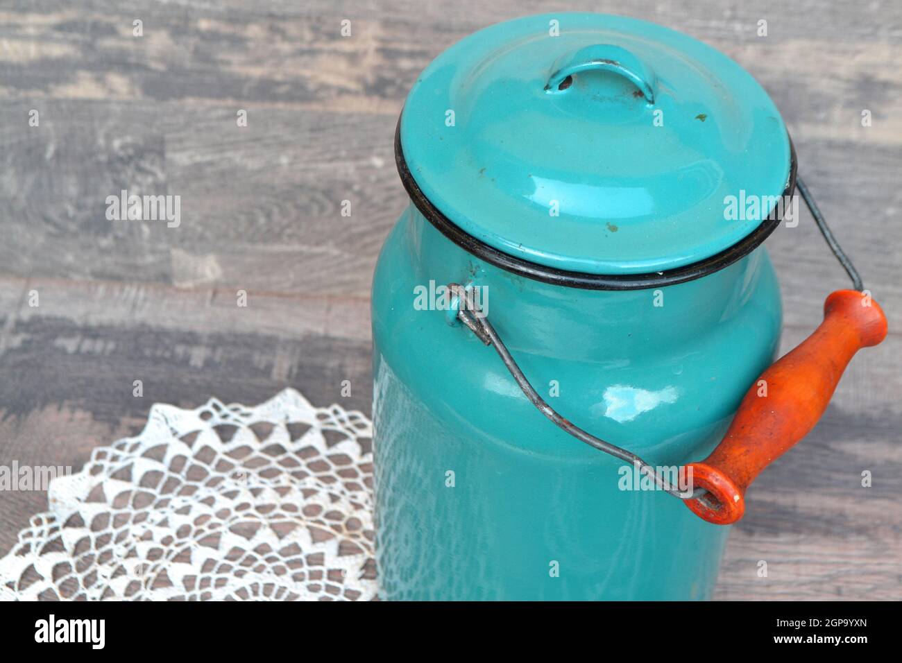 Old blue milk can onwooden background in vintage style close up Stock ...