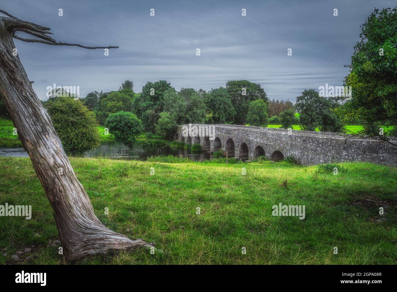 Old, 12th century stone arch Bective Bridge over Boyne River with large ...