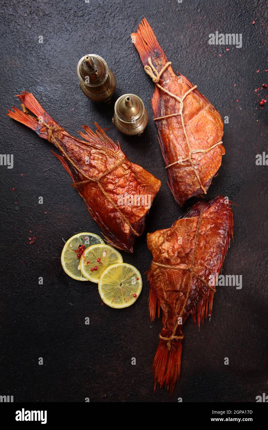 Smoked sea bass on a black background. Marine useful fish. Vertical ...