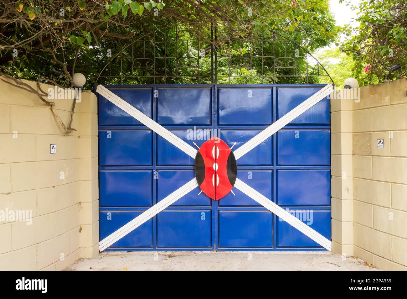 Iron gate with a white cross and a shield in a village near the town of ...