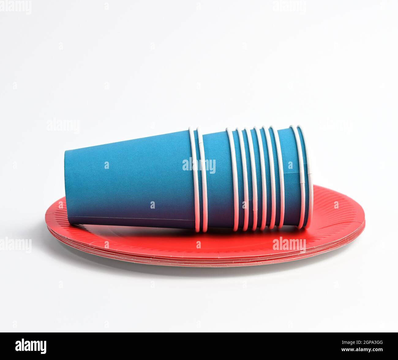 stack of blue paper cups and red round plates on a white background ...