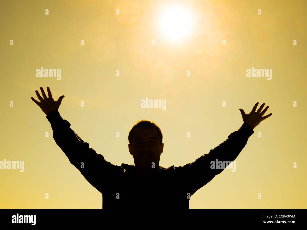 Silhouette of a man against the background of the sun and yellow at ...