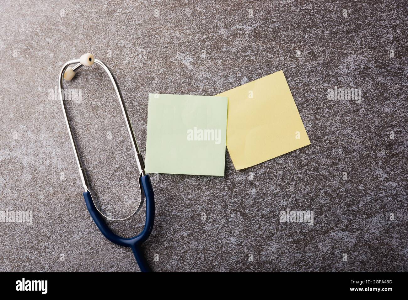 Above the doctor office table desk with blank paper stick note yellow ...
