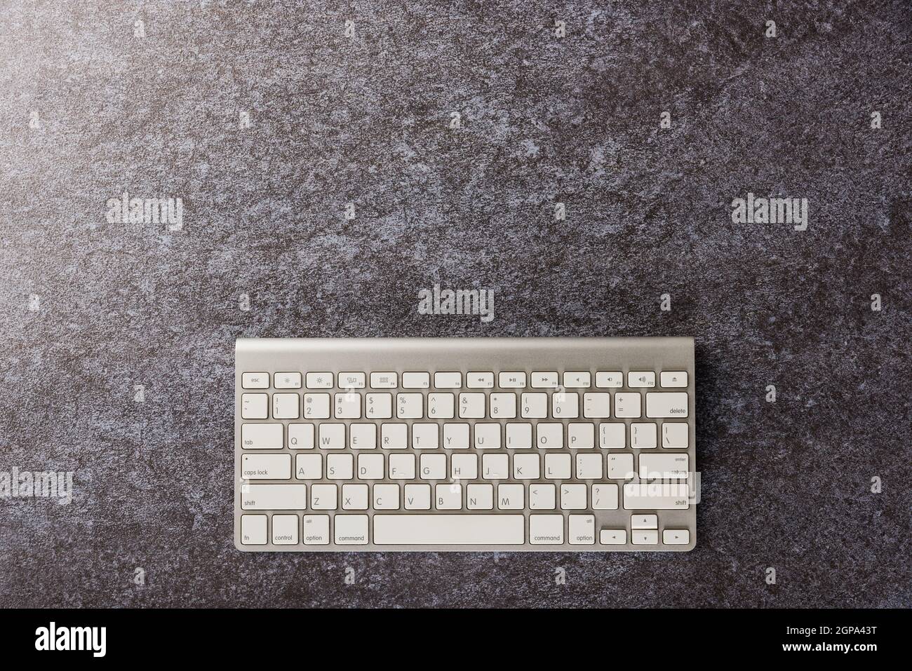 Top view flat lay of a modern white computer keyboard on office desk ...