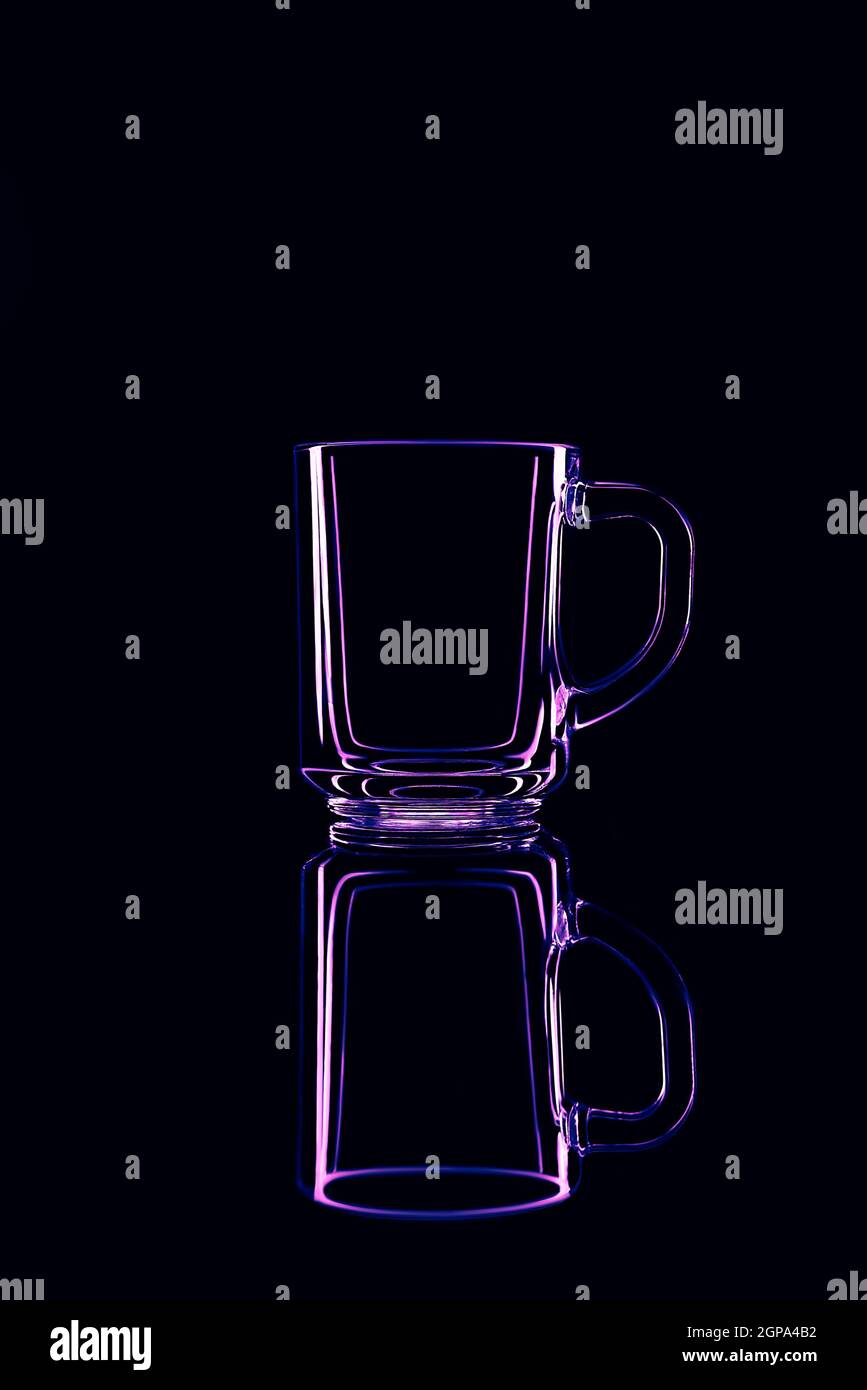 Just a glass on a black background with a reflection. Purple colors ...