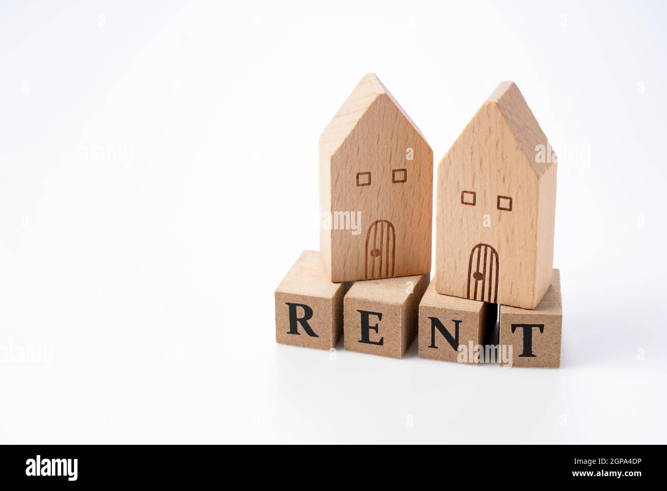 Toy house made of wood and RENT blocks placed on a white background ...