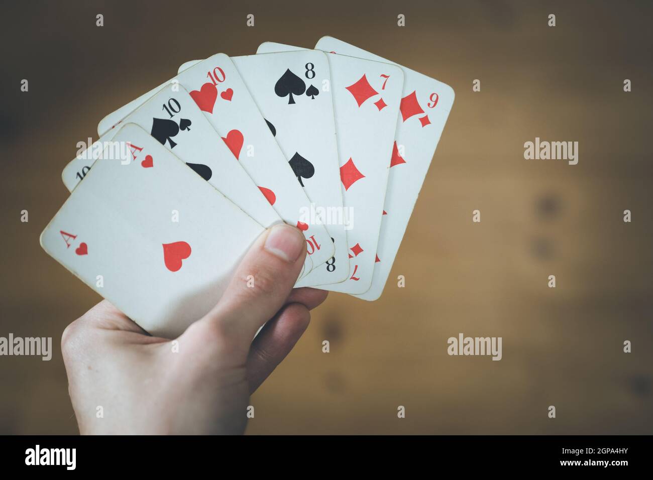 Hands holding playing cards casino hi-res stock photography and images ...