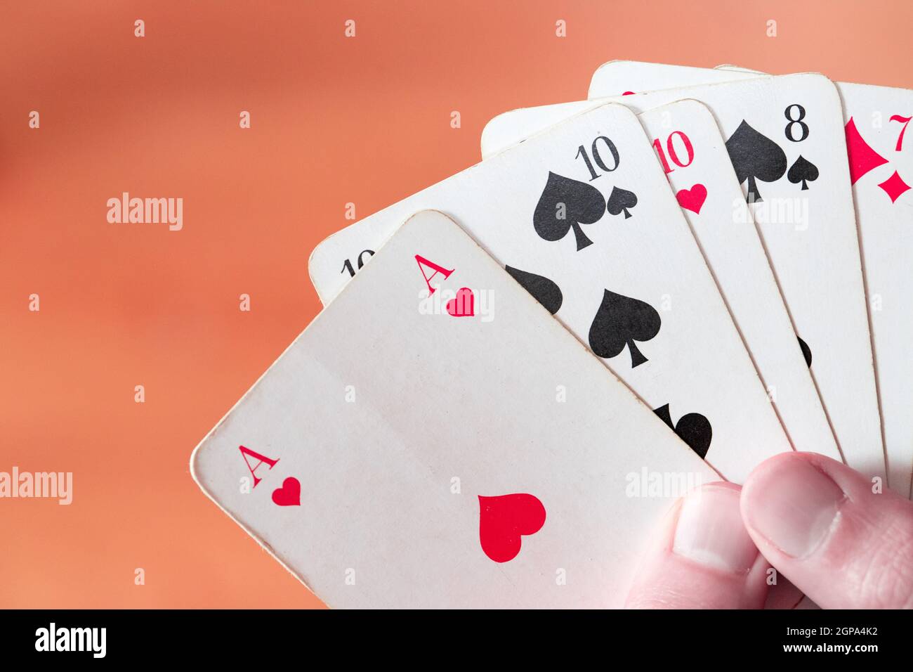 Man is playing cards, cutout of his hands Stock Photo - Alamy