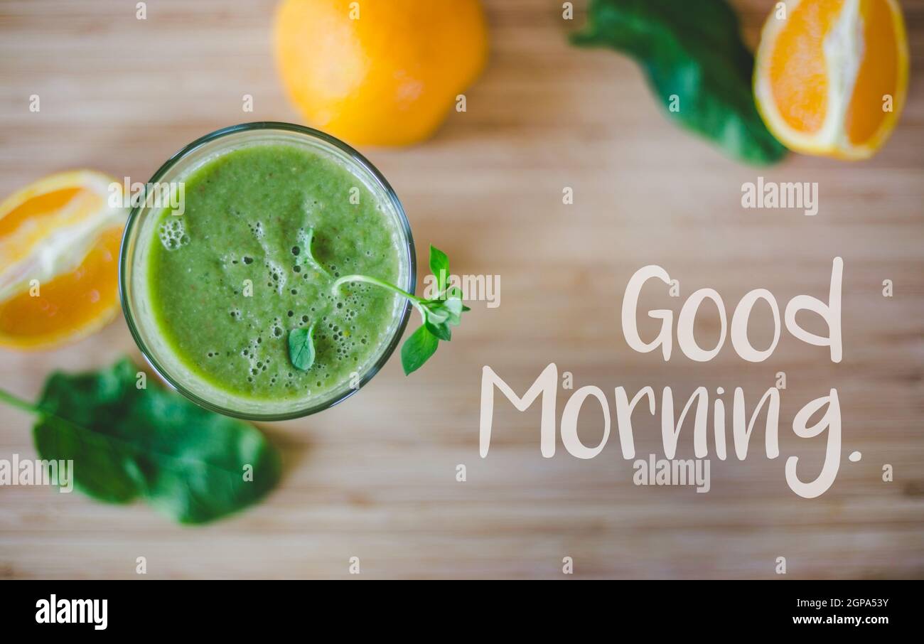 Arrangement of a fresh green healthy smoothie and fruits on a wooden ...