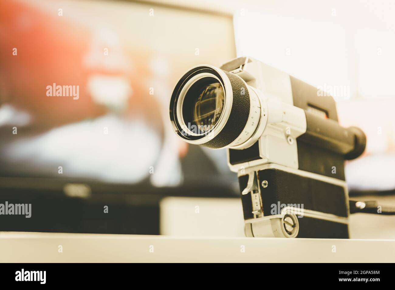 Vintage old movie camera, computer for cutting in the blurry background ...