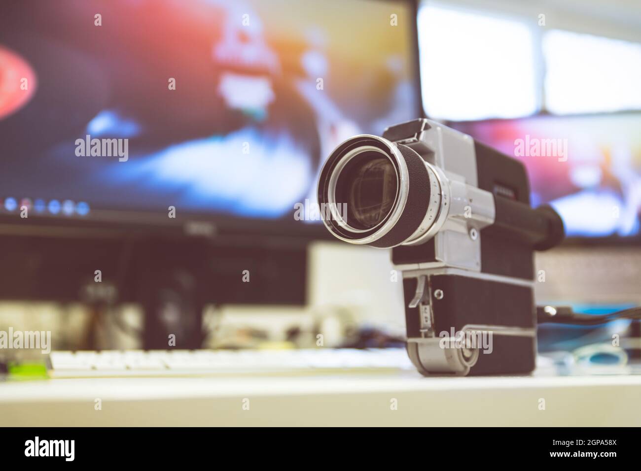 Vintage old movie camera, computer for cutting in the blurry background ...