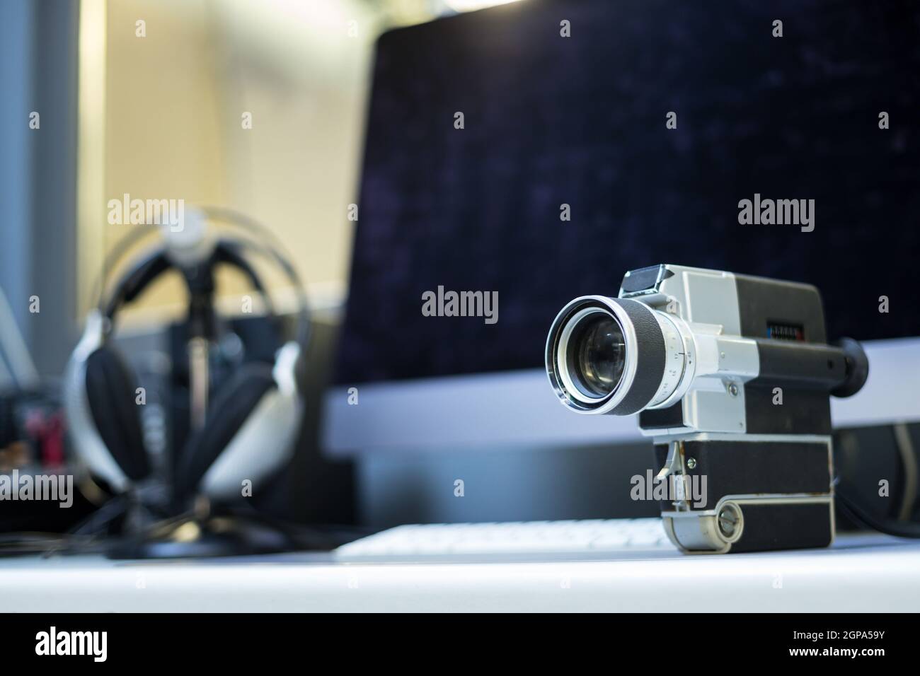 Vintage old movie camera, computer for cutting in the blurry background ...