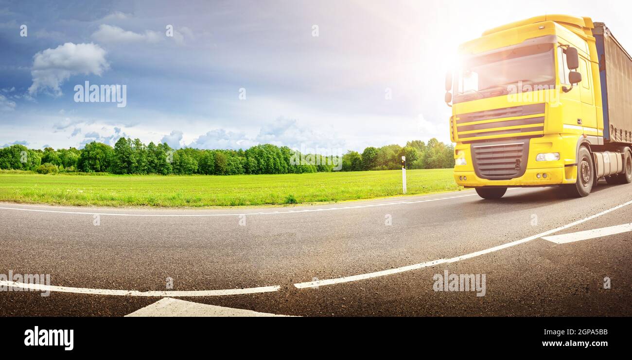 Lorry on the asphalt road. Truck moving on the highway in summer Stock ...