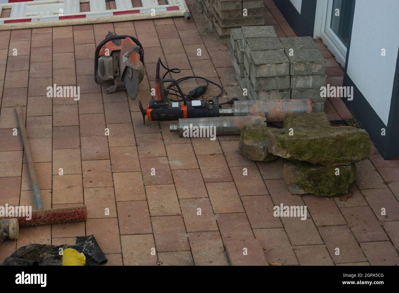 Concrete drilling with industrial boring machine next to it is a stone ...