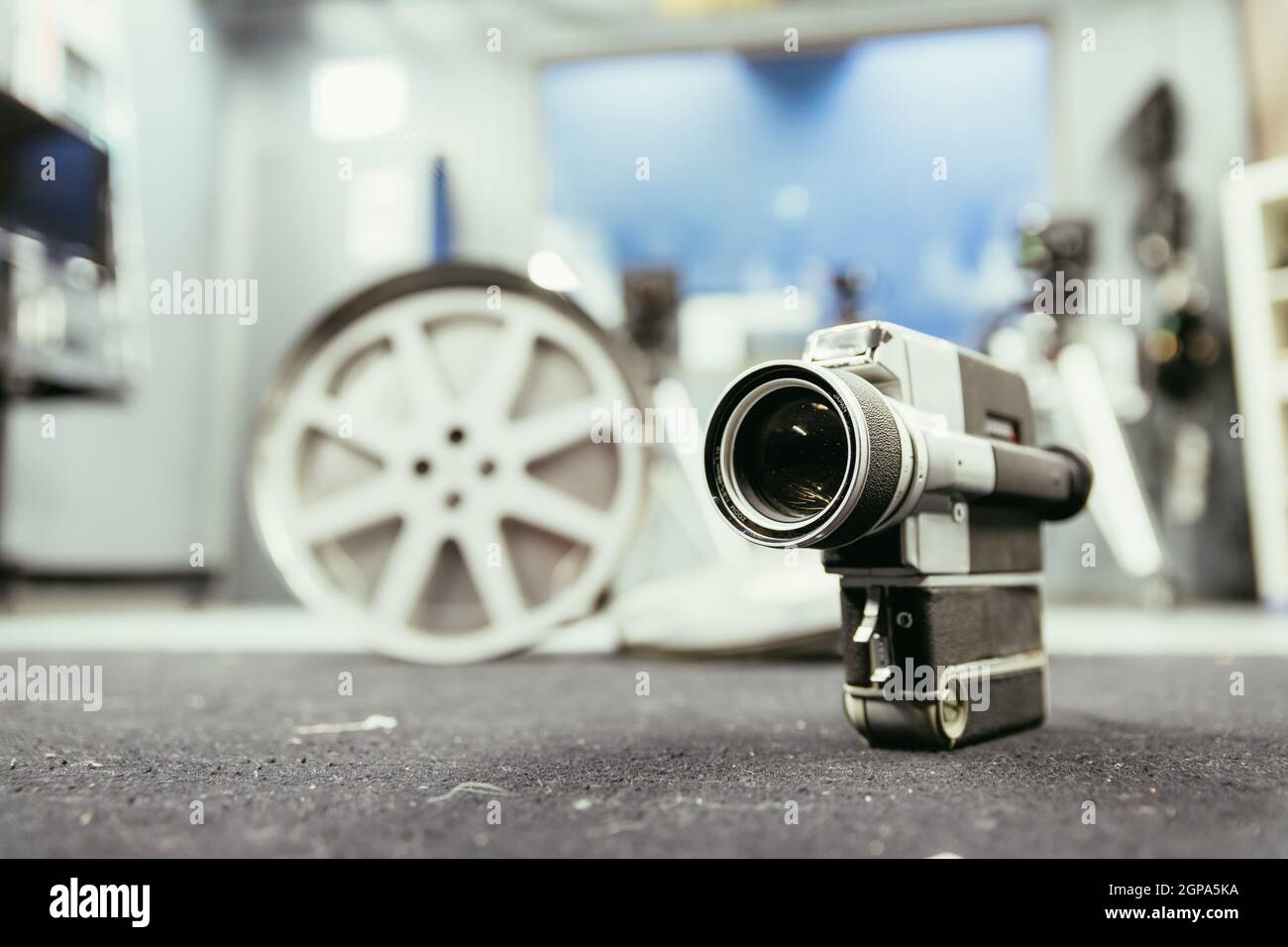 Vintage old movie camera, production studio in the blurry background ...