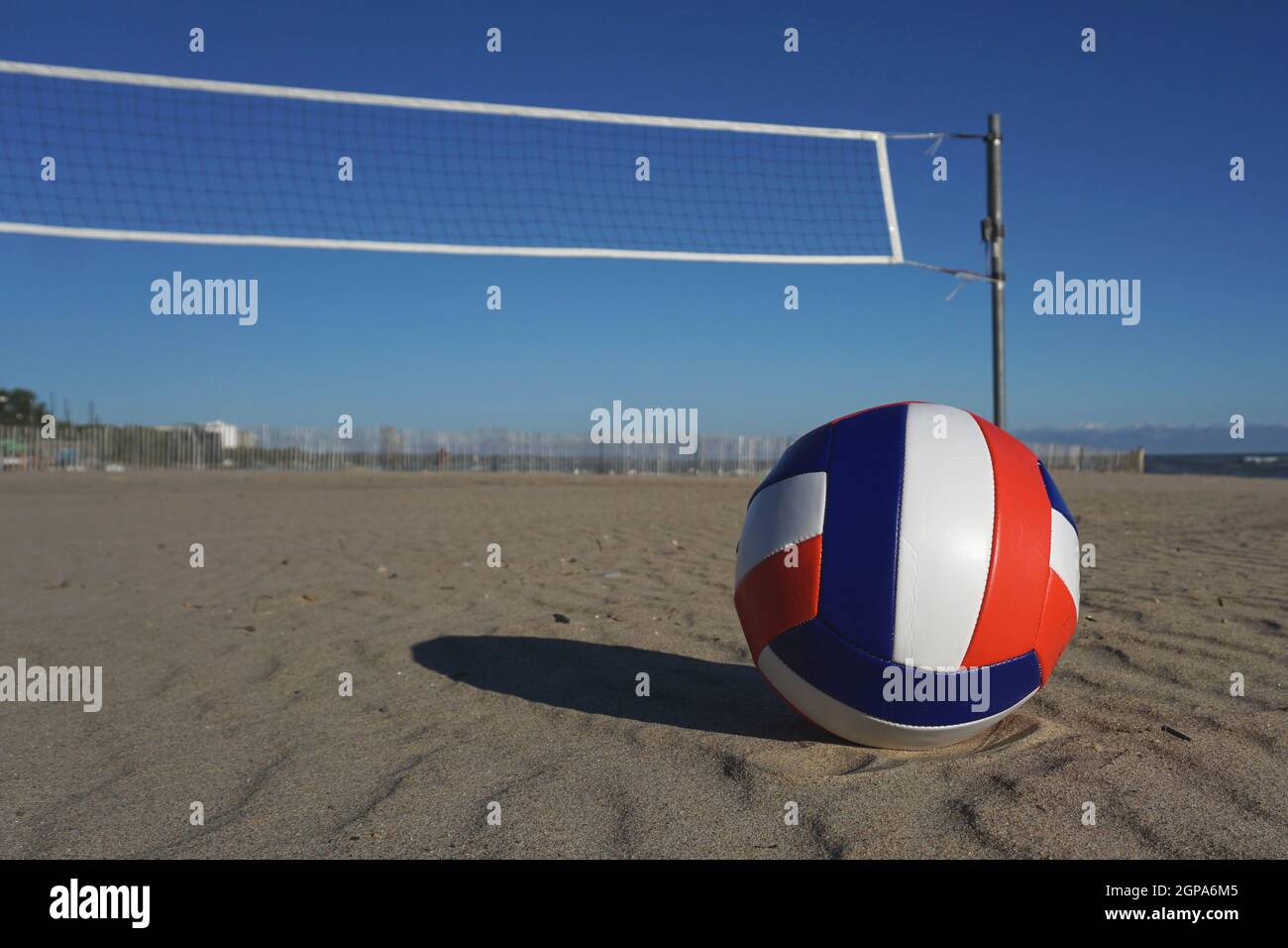 Beach volleyball on the sand in front of a net on Lake Michigan's ...