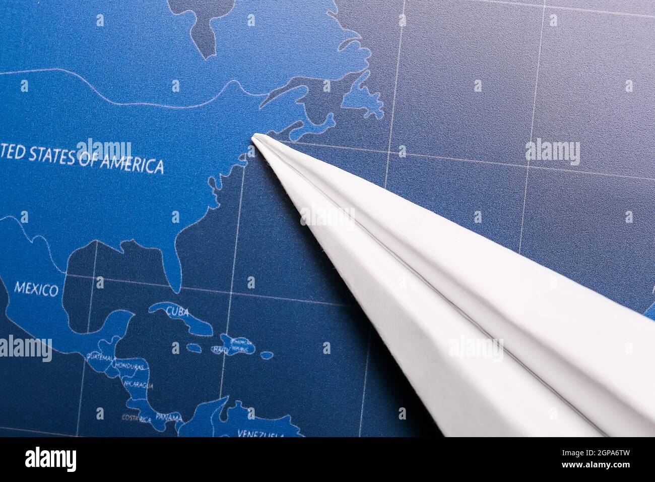 Paper airplane on world map Stock Photo - Alamy