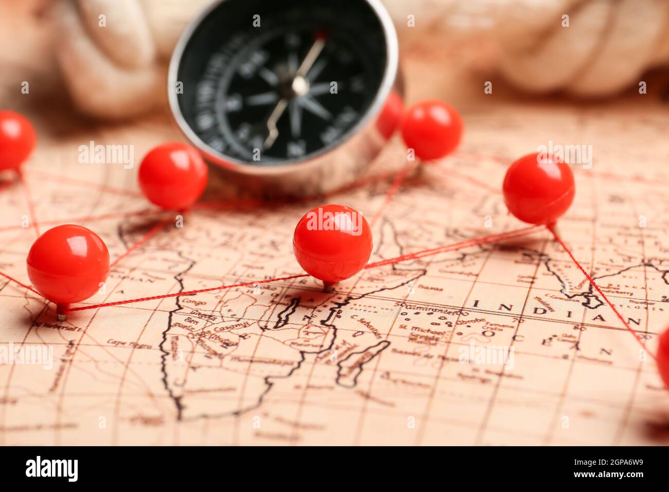 World map with pins and compass, closeup Stock Photo - Alamy