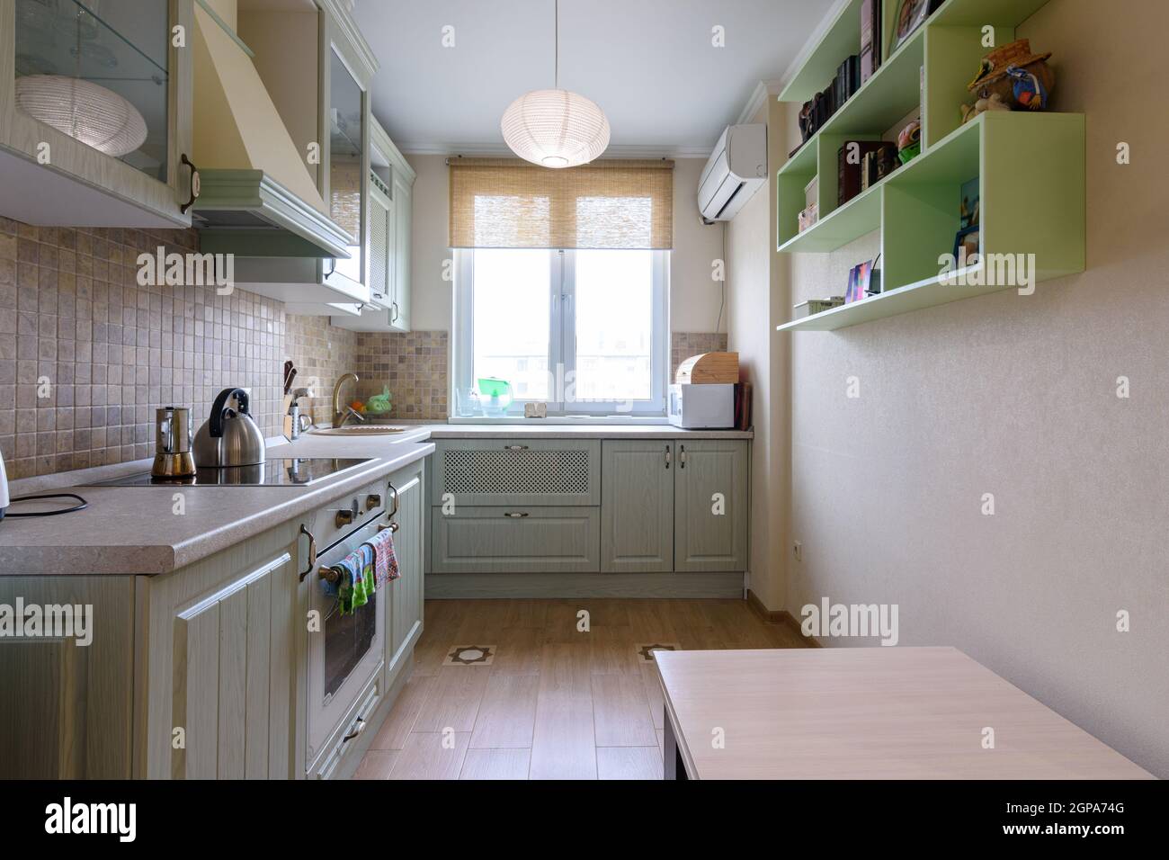 The interior of a light ordinary kitchen with a spacious kitchen set ...