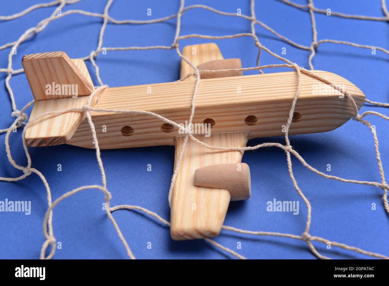 Wooden airplane and net on color background. Concept of hostage Stock ...