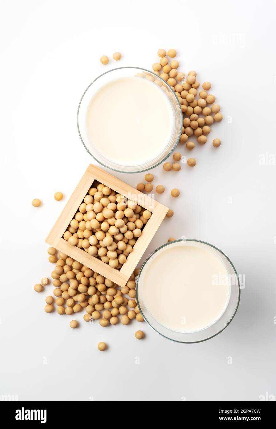 Soy milk and soybeans in a glass placed on a white background. View ...