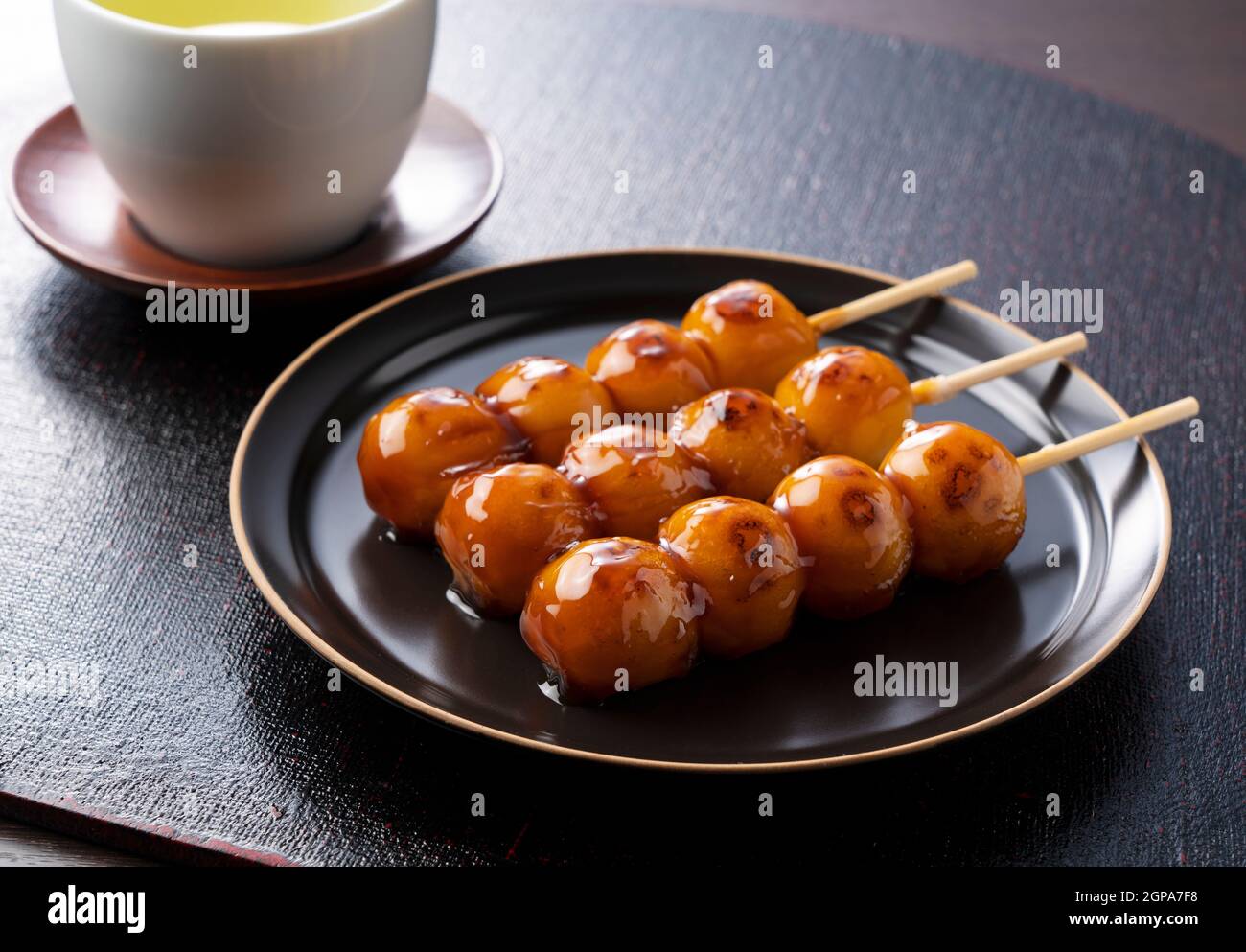 Mitarashi dango and green tea on a Japanese-style tray. Image of ...