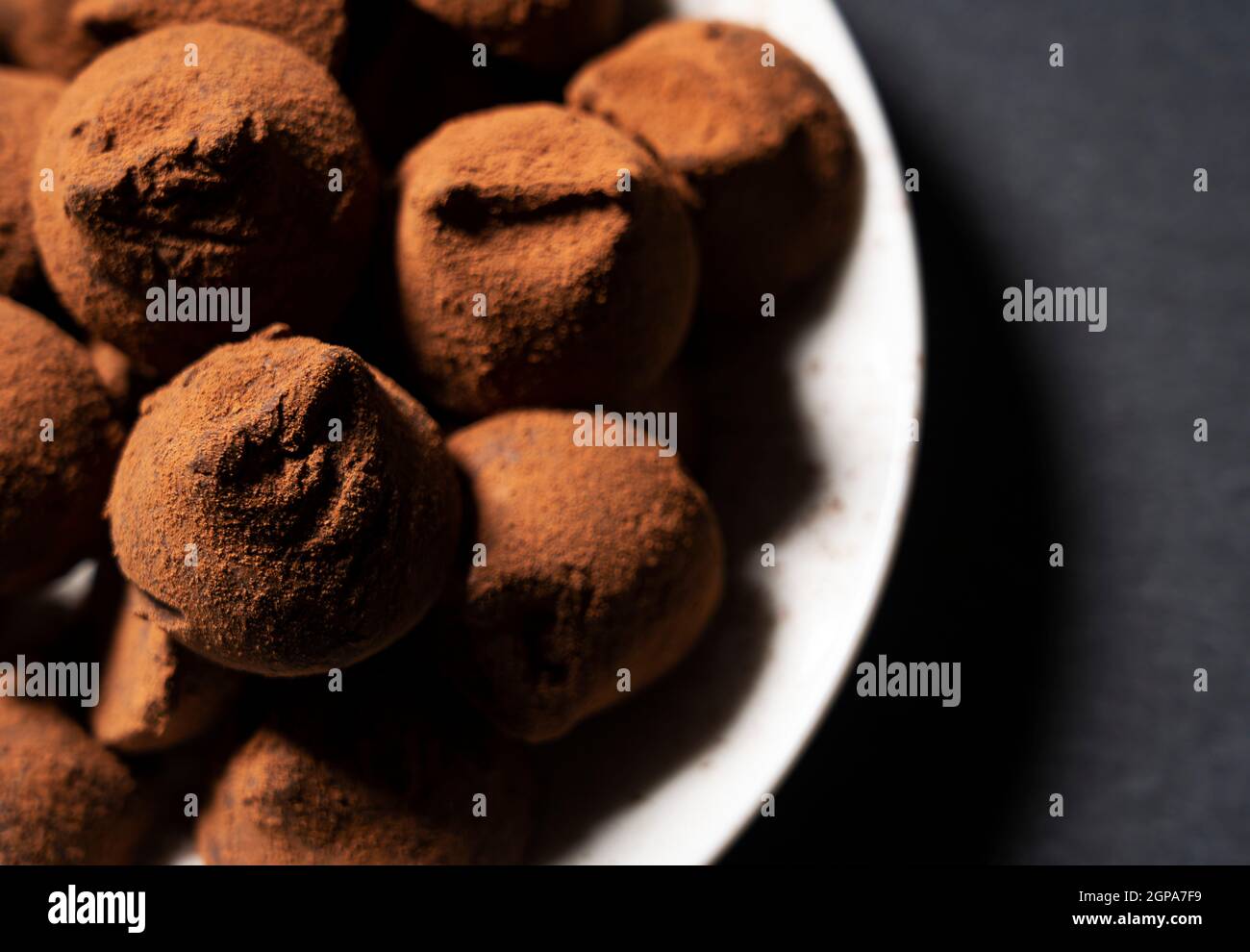 Chocolate truffles on a plate placed on a stone plate Stock Photo - Alamy