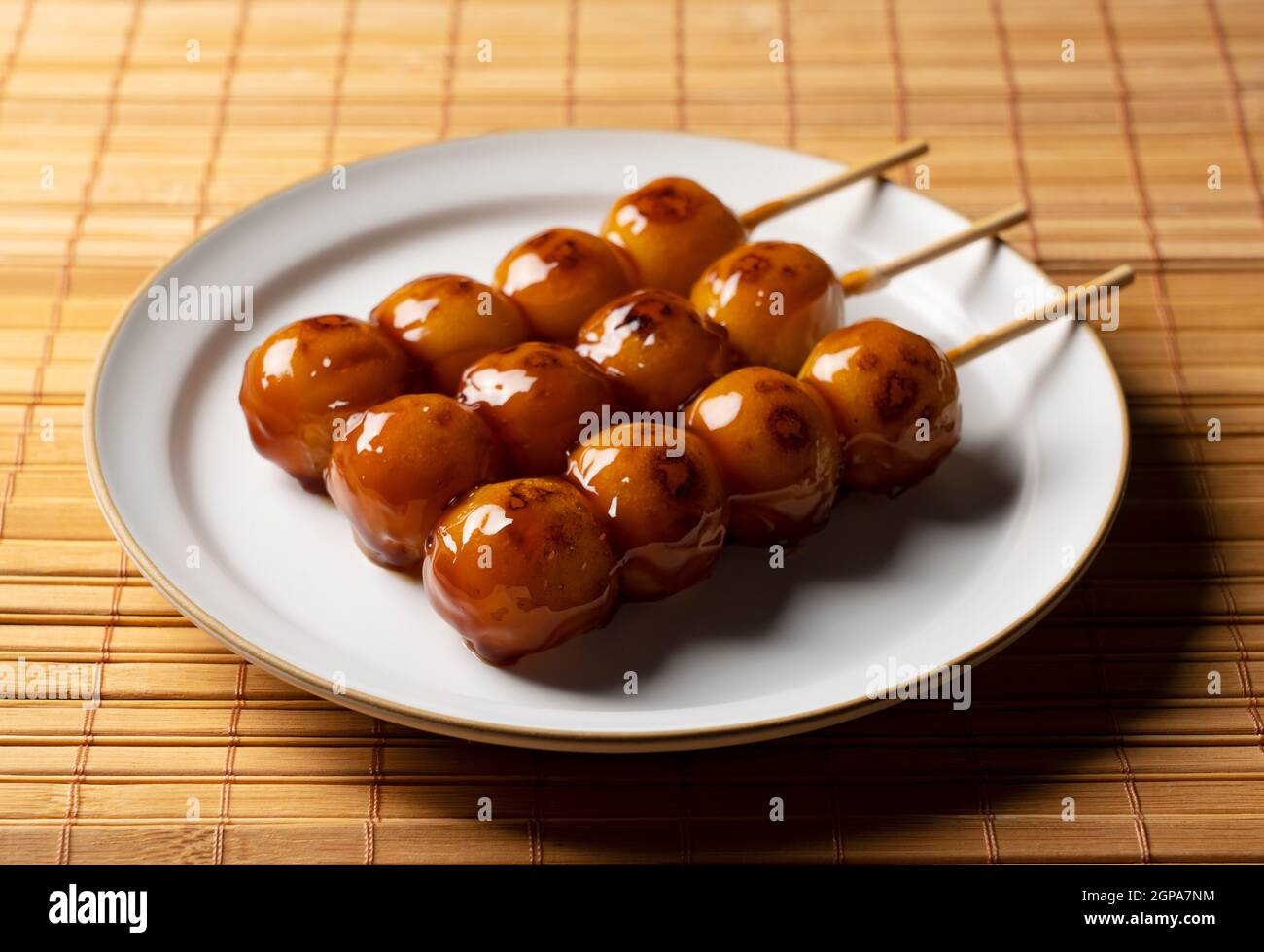 Mitarashi dango placed on a wooden background. The image of a mitarashi ...