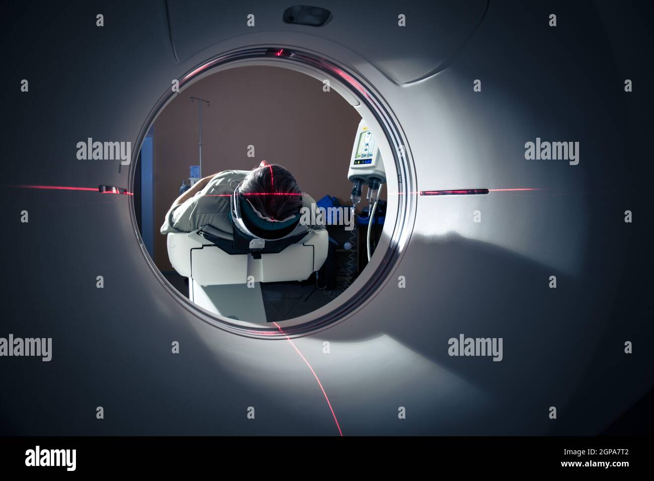 Senior man going through a Computerized Axial Tomography (CAT) Scan ...