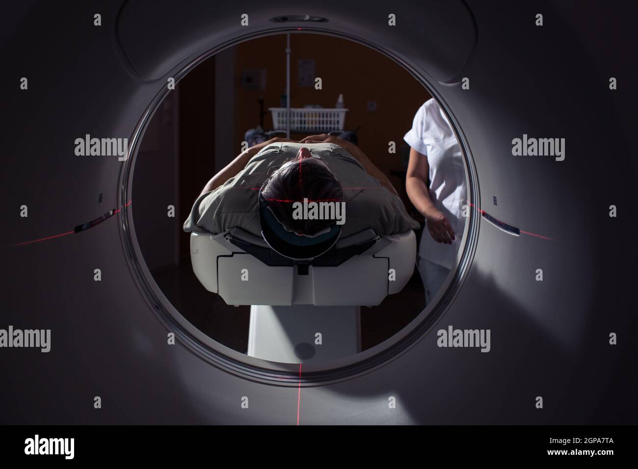 Senior man going through a Computerized Axial Tomography (CAT) Scan ...