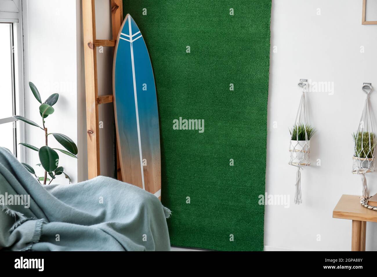 Interior of stylish room with surfboard Stock Photo - Alamy