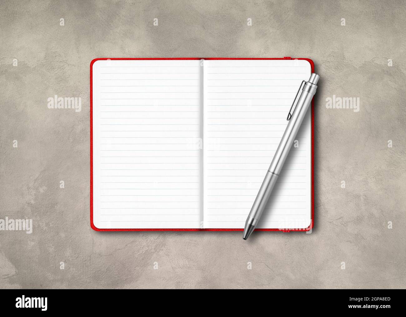 Red open lined notebook mockup with a pen isolated on concrete ...