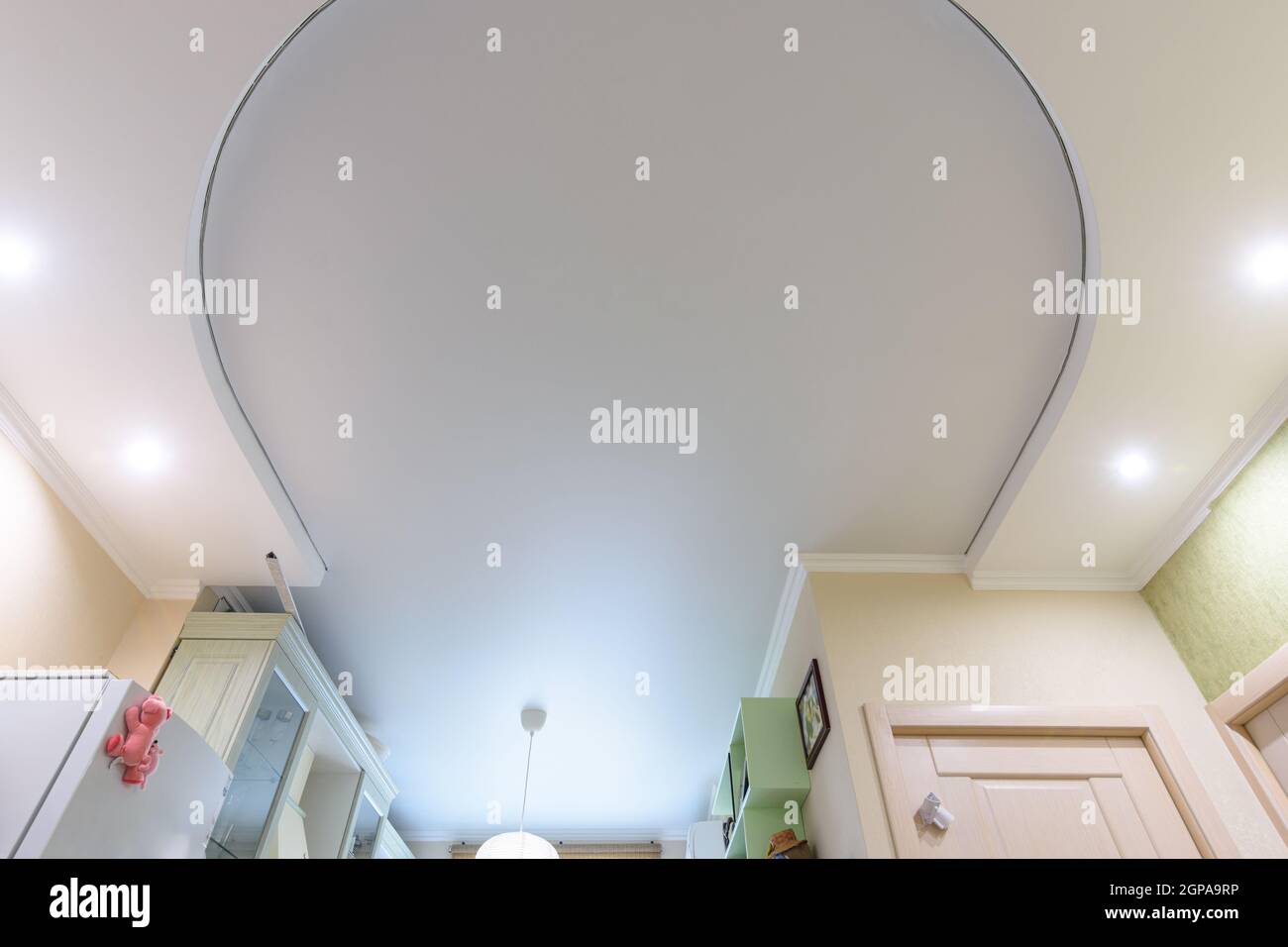 Two-level oval suspended ceiling in the interior of the living room ...