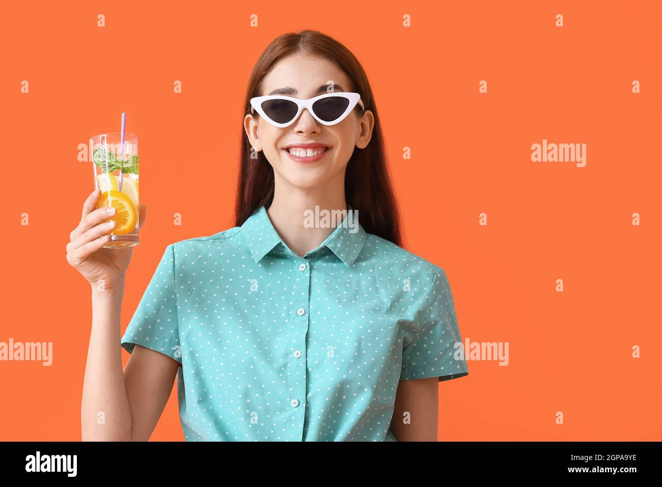Beautiful young woman with fresh lemonade on color background Stock ...