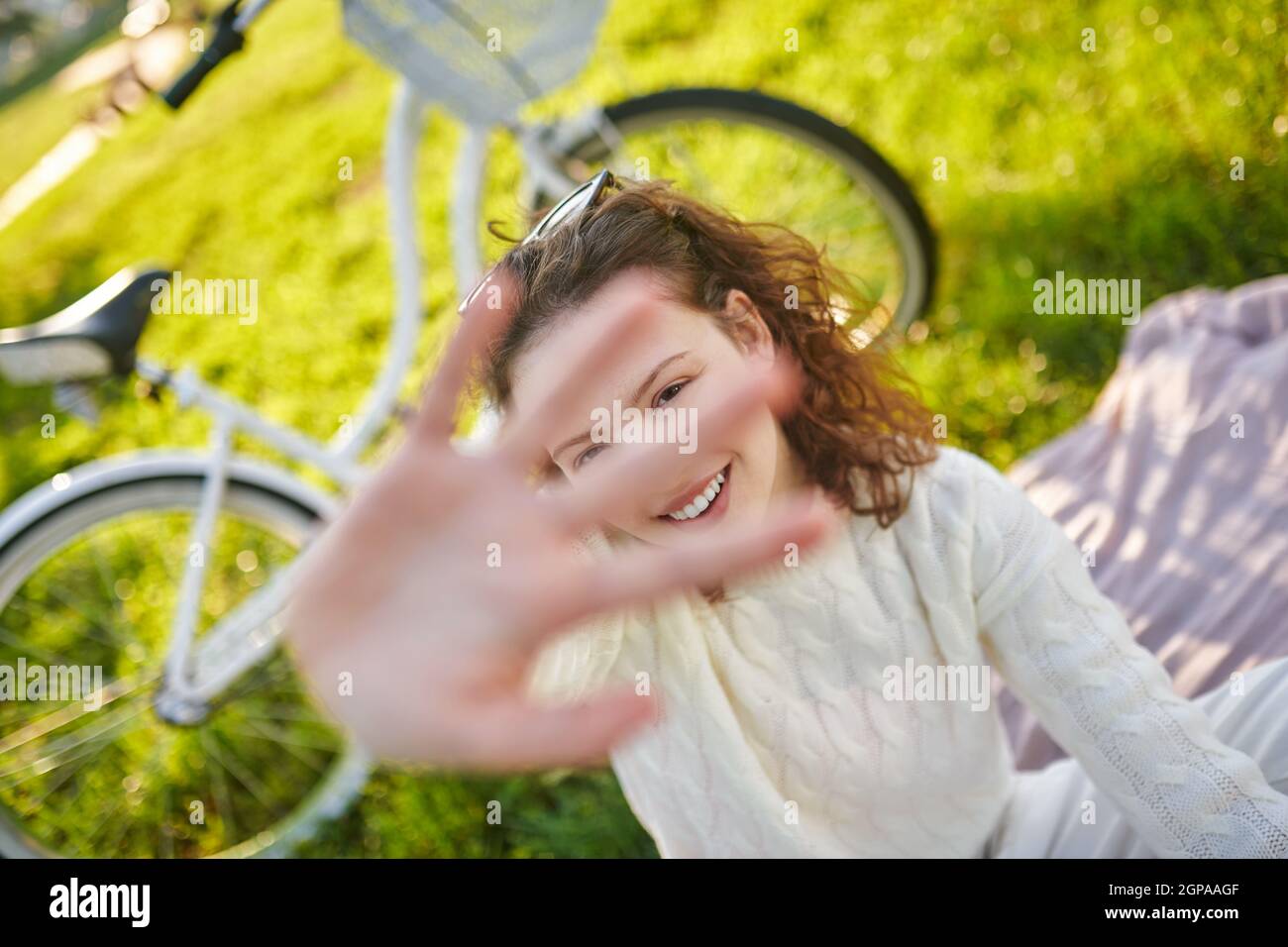 A girl raising her hand and protecting from photos Stock Photo - Alamy