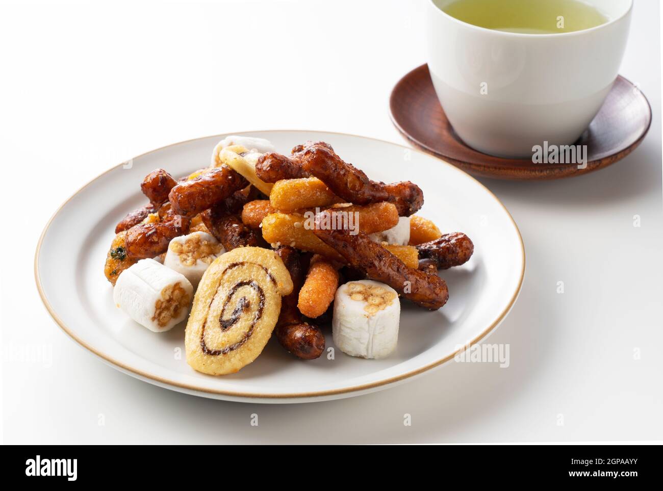 Various kinds of karinto and green tea placed on a white background ...