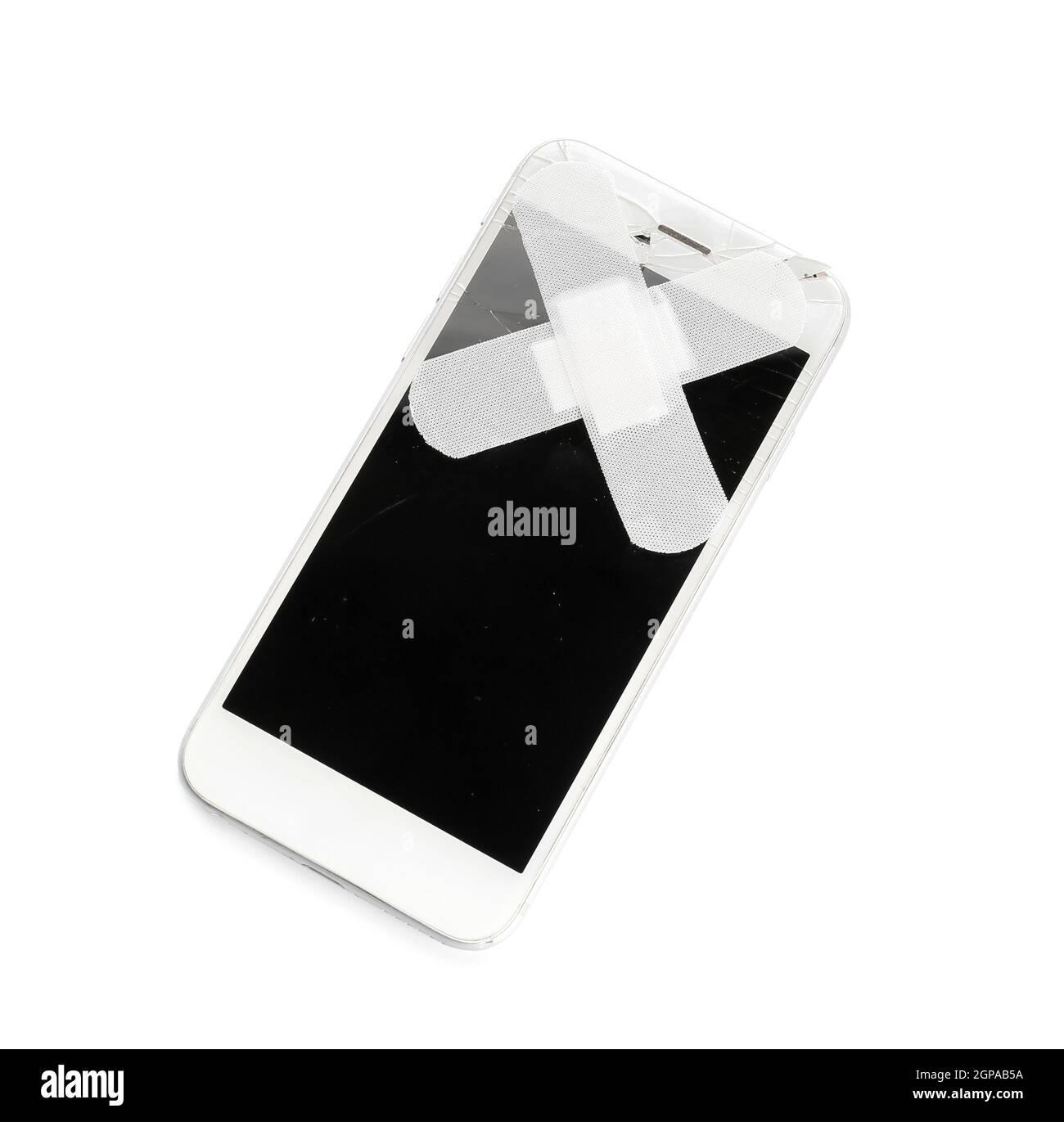 Mobile phone with broken screen and medical plasters on white ...