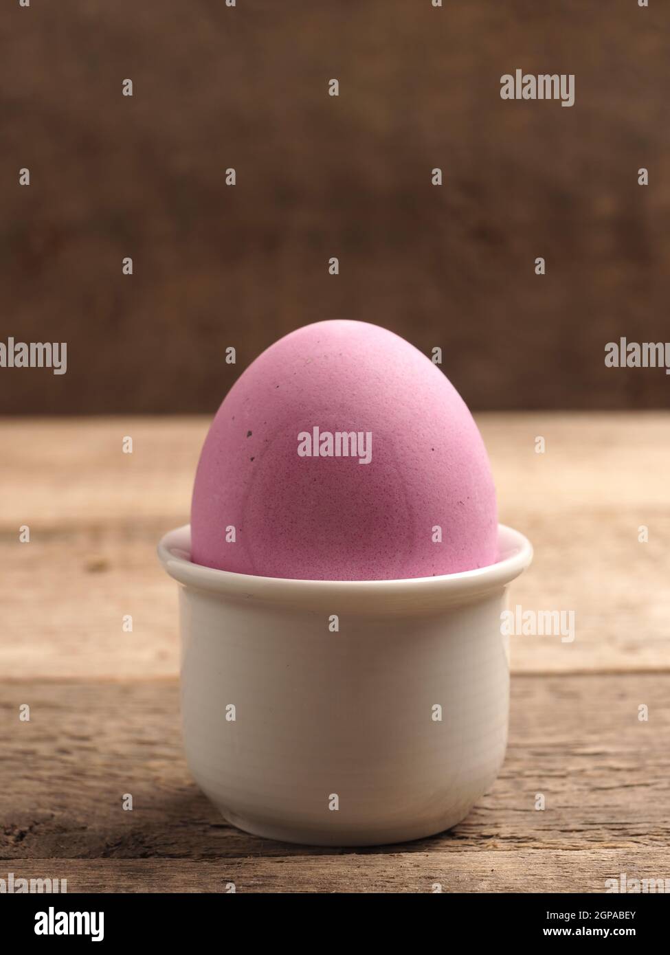 Naturally colored organic egg on a rustic table with space for text ...