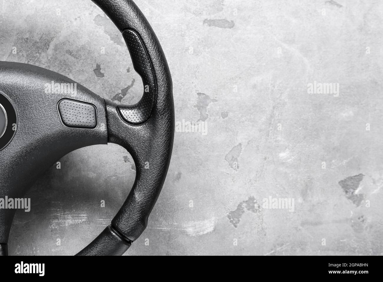Modern steering wheel on grey background, closeup Stock Photo - Alamy